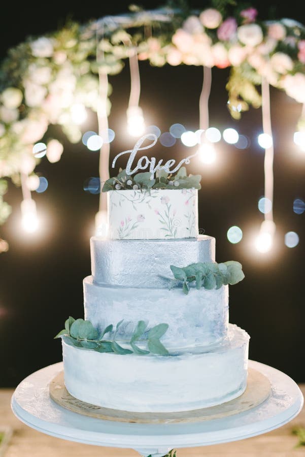 Decorated by Flowers Multilevel Wedding Cake with Lights on the ...