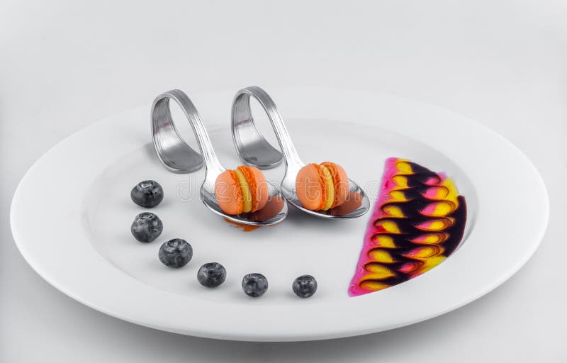 Decorated Plate Orange Macrons with Raspberry Stock Photo - Image of ...