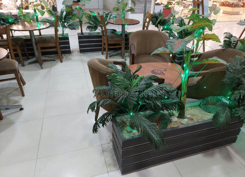 A Decorated Tea & Coffee Corner with Trees and Green Light. Stock Photo ...