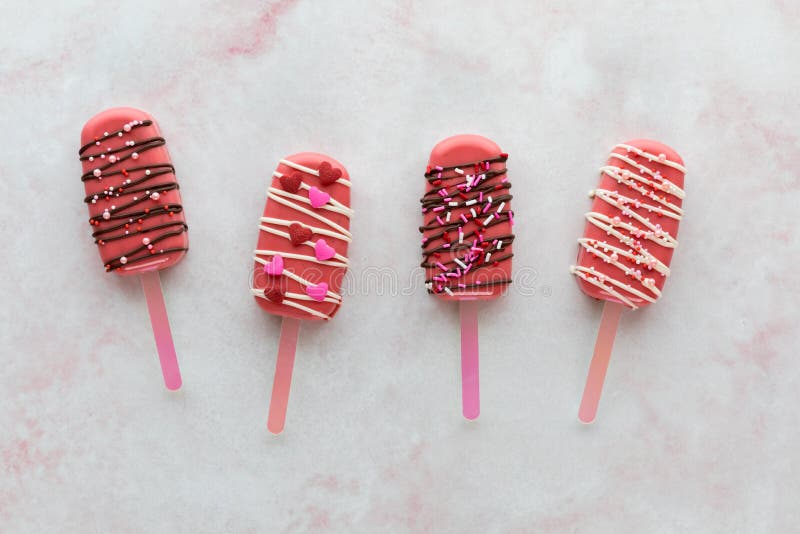Decorated Valentine Cakesicles with Candy Melt Drizzle and Sprinkles ...