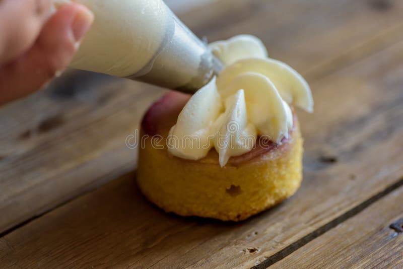 Decorating a Cake with Cream Using Piping Bag Stock Photo - Image of ...