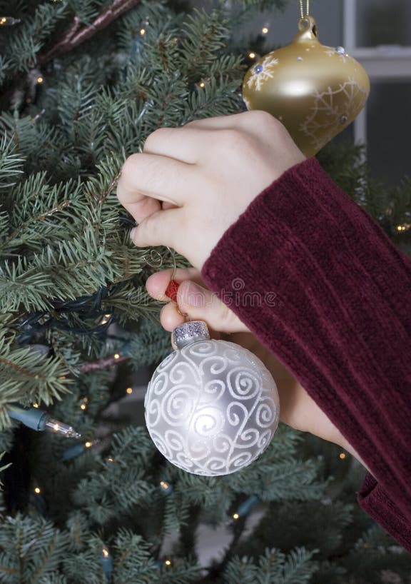 Decorating Christmas Tree stock image. Image of hanging - 1118121