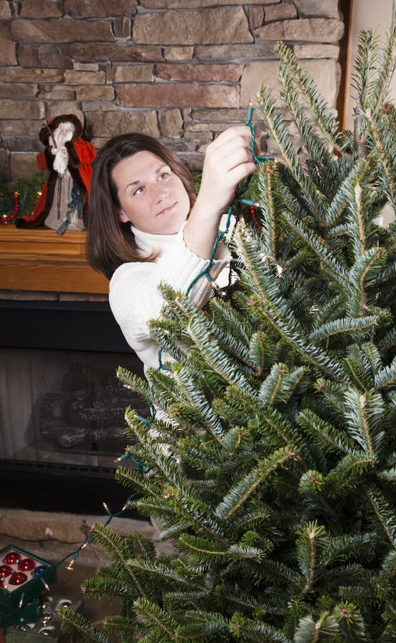 Decorating Christmas tree stock photo. Image of female - 26865554