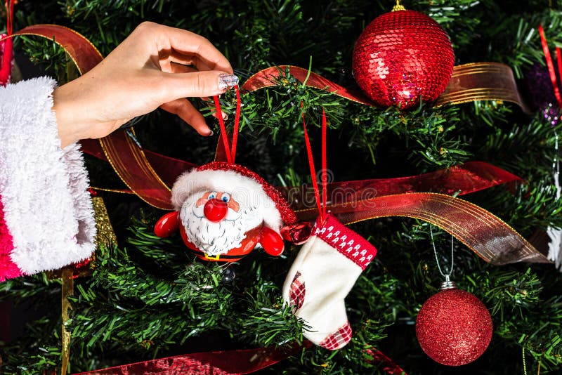Decorating Christmas Tree, Hand Putting Christmas Decorations on Fir ...