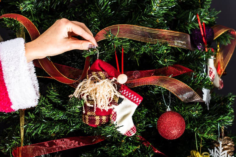Decorating Christmas Tree, Hand Putting Christmas Decorations on Fir ...