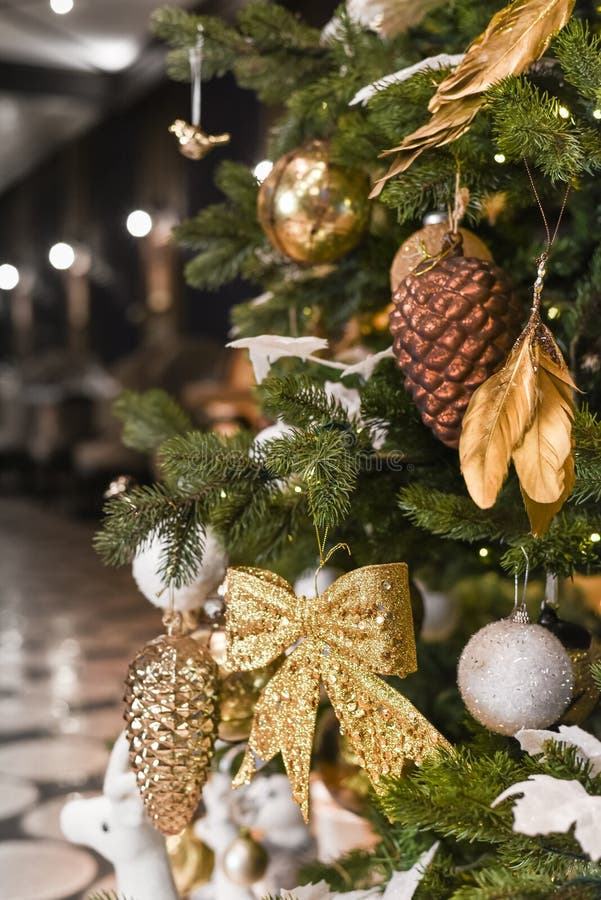 Decorating the Christmas Tree with Luxurious Gold Ornaments Stock Photo ...