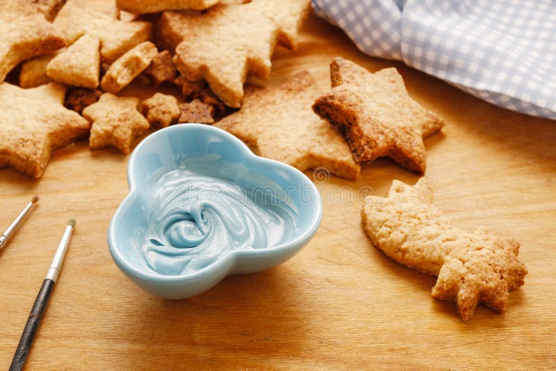 Decorating Gingerbread Cookies with Blue and White Icing. Stock Photo ...