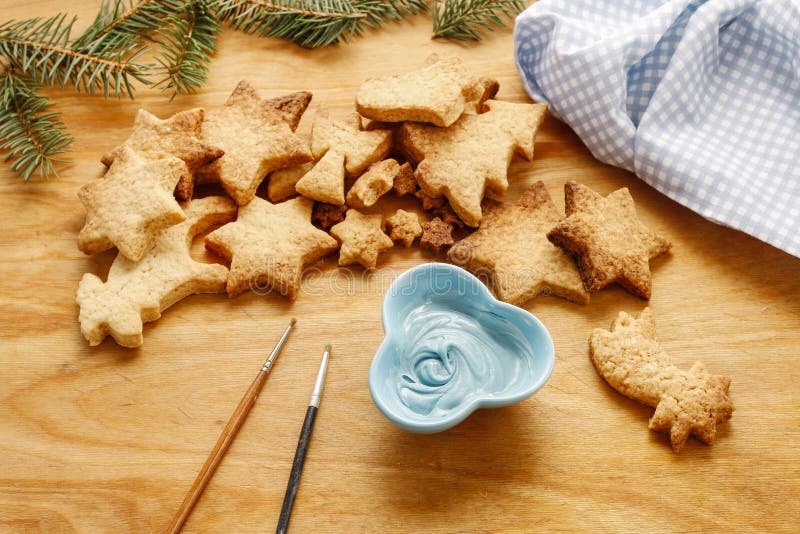 Decorating Gingerbread Cookies with Blue and White Icing. Stock Image ...