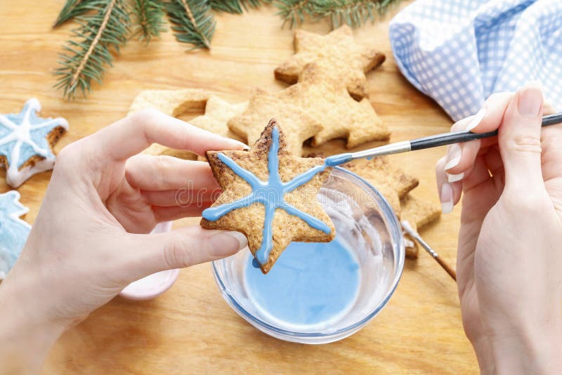 Decorating Gingerbread Cookies with Blue and White Icing. Stock Image ...