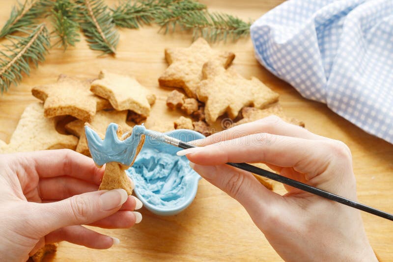 Decorating Gingerbread Cookies with Blue and White Icing. Stock Photo ...