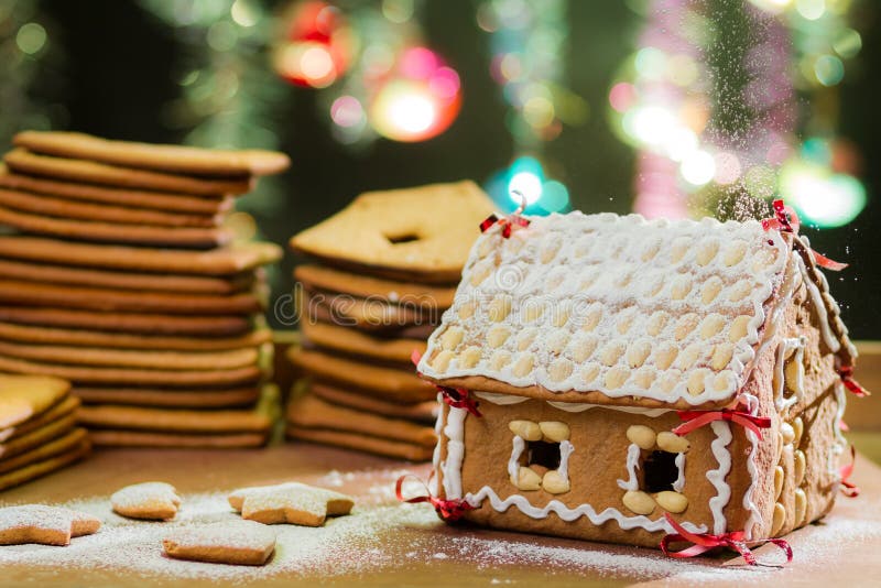 Decorating Gingerbread Cottage with Icing Sugar Stock Photo - Image of ...