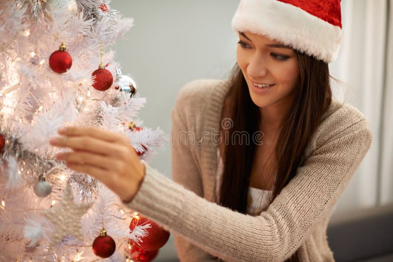 Decorating the Perfect Christmas Tree. an Attractive Young Woman ...