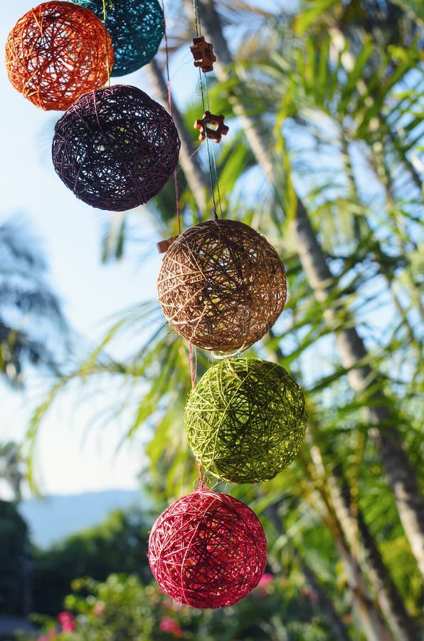 Colorful Balls Made of Natural Thread Hanging in Front of Palm Tree ...