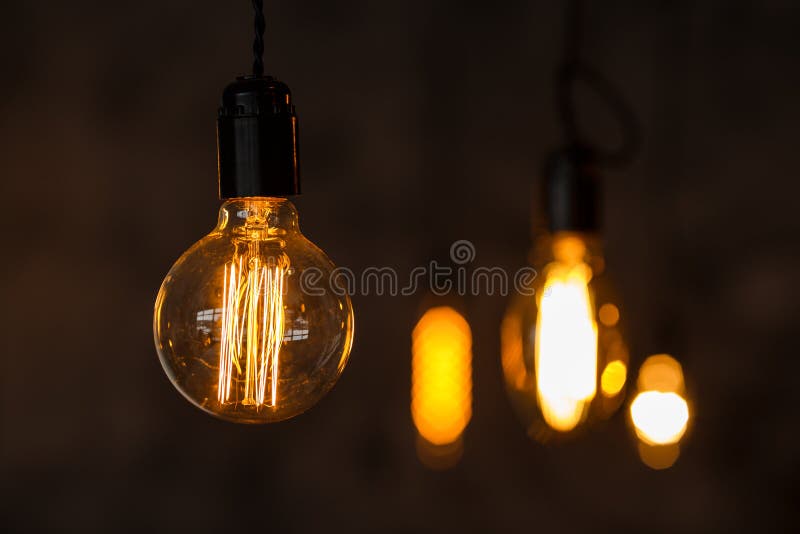 Decorative Antique Edison Style Light Bulbs on the Dark Wall Background ...