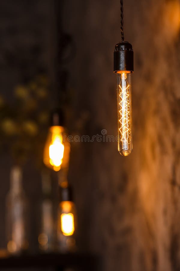 Decorative Antique Edison Style Light Bulbs on the Dark Wall Background ...