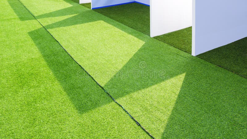 Decorative Artificial Grass Mat and White Booth Partitions on Patio of ...