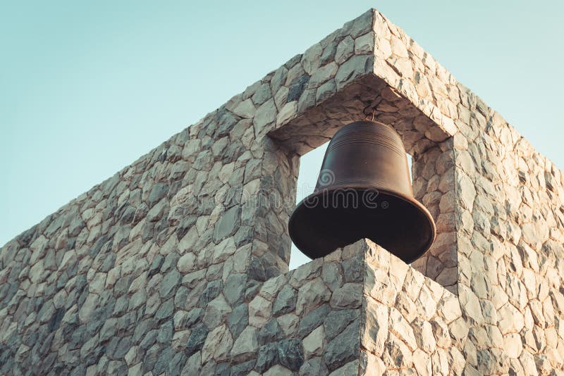 Decorative Bell Hanging on a Stone Wall in Antique Village Stock Photo ...