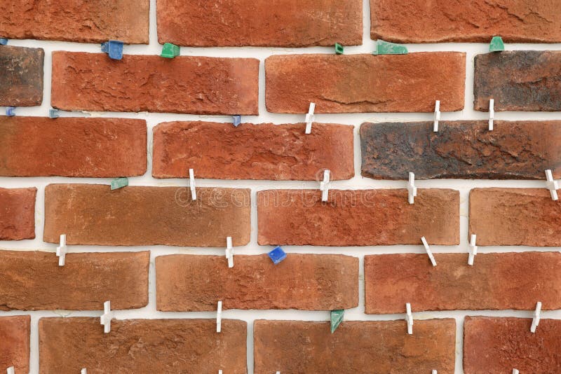 Decorative Bricks with Tile Leveling System on Wall Stock Photo - Image ...