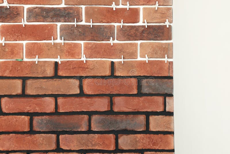 Decorative Bricks with Tile Leveling System on White Wall Stock Photo ...
