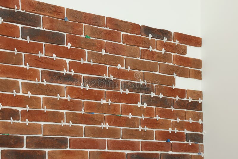 Decorative Bricks with Tile Leveling System on White Wall Stock Image ...