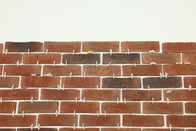 Decorative Bricks with Tile Leveling System on White Wall Stock Image ...