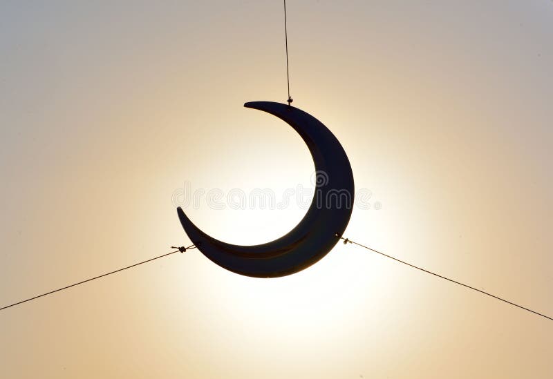 Decorative Crescent Moon Supported with Strings with Sun Besides Stock ...