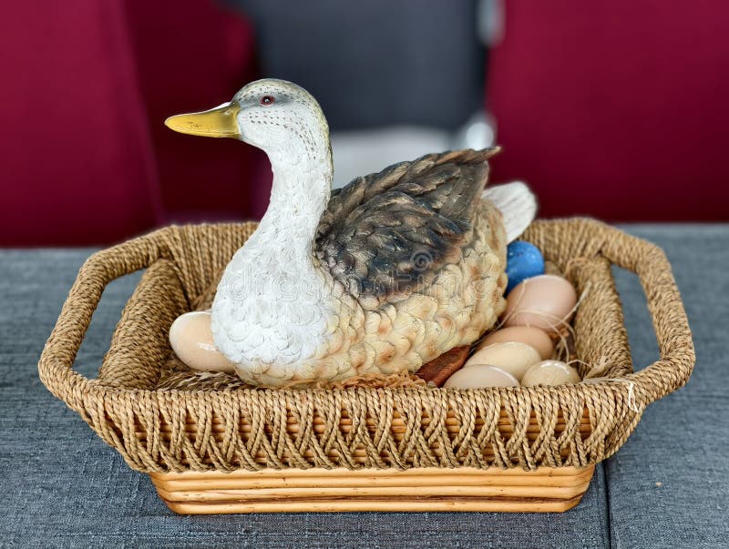 Decorative Duck Figurine in a Basket with Various Colored Eggs Stock ...