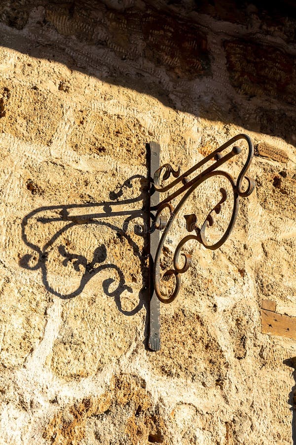 Decorative Forged Bracket on a Stone Wall. Stock Photo - Image of iron ...