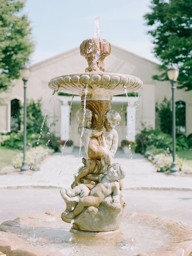 Decorative Fountain Featuring Cherubs in a Tranquil Garden Setting ...