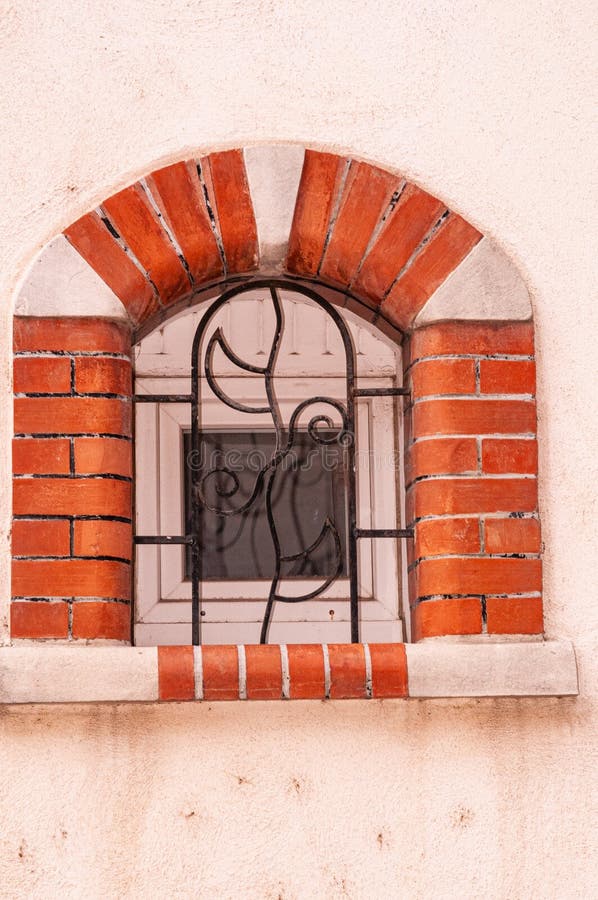Decorative Iron Bares, Protecting a Small, Window with a Red Brick ...