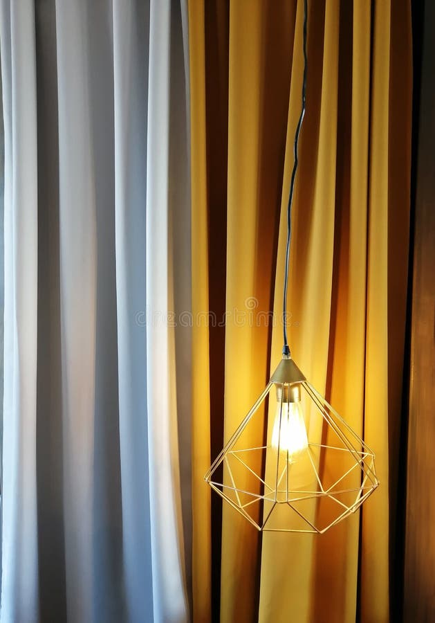 Decorative Light Bulb Made of Wire, Suspended on a Cable, Against the ...