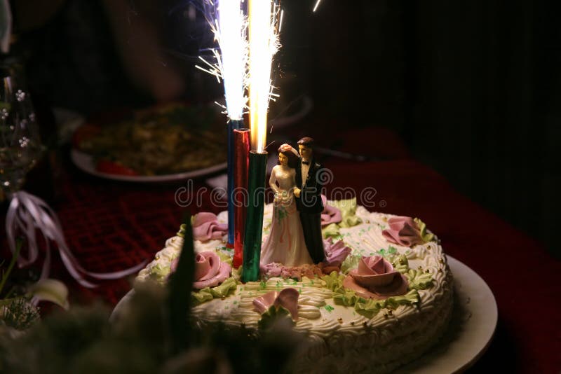 Decorative Pair of Newlyweds on Top of a Wedding Cake with a Bur Stock ...