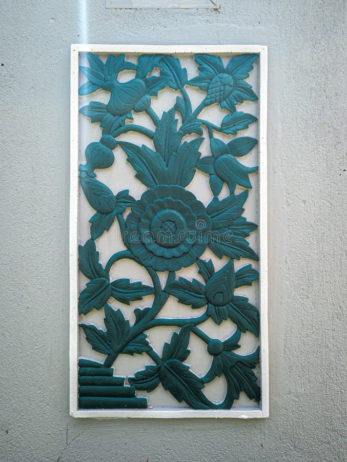A Decorative Panel Featuring a Floral Relief Design in a Deep Green ...
