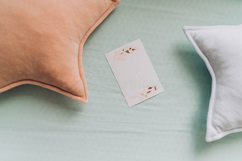 Decorative Pillows beside a Floral Card on a Soft Surface Stock Image ...