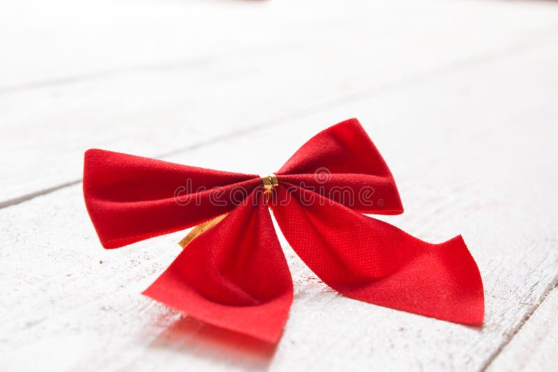 Decorative Red Ribbon and Bow on a Background of White Painted R Stock ...