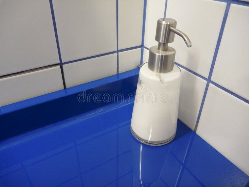 Decorative Soap Bottle on a Blue Table Stock Photo - Image of round ...