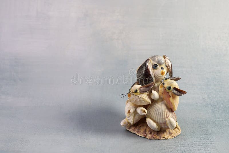 Shell Dog Statue with Two Kittens on a Light Gray Background Stock ...
