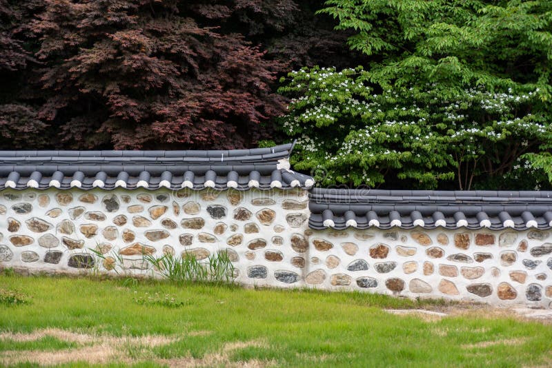 Decorative Stone Wall Fence with Lush Trees in the Background Stock ...