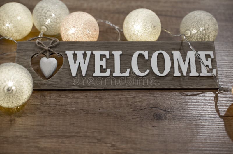 Decorative Text Welcome with Heart and Lights on the Wooden Table Stock ...