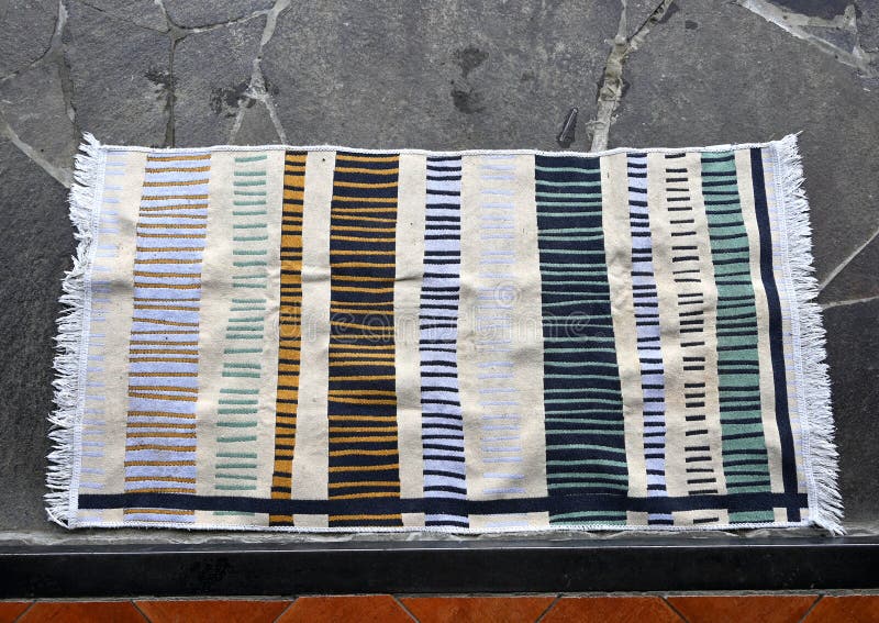 Decorative Textile with Geometric Patterns Displayed on a Stone Surface ...