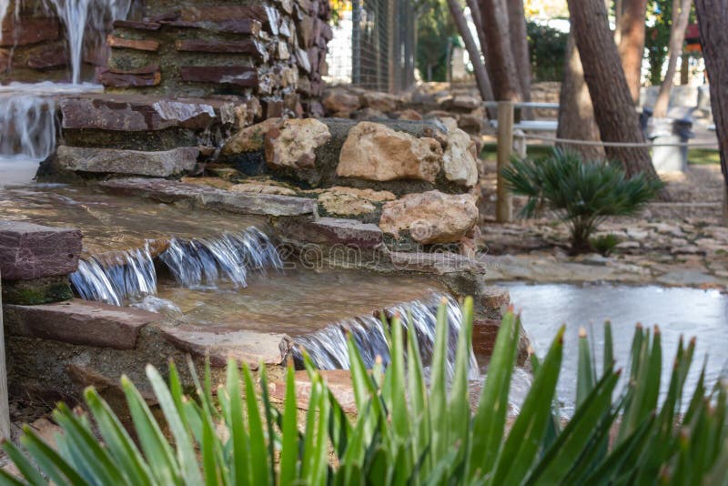 Decorative stone waterfall stock image. Image of green - 133945413