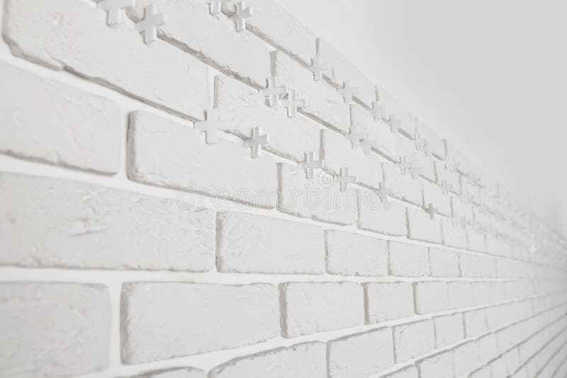 Decorative White Bricks with Tile Leveling System on Wall Stock Photo ...