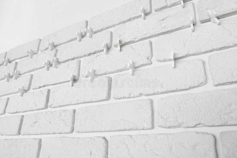 Decorative White Bricks with Tile Leveling System on Wall Stock Image ...