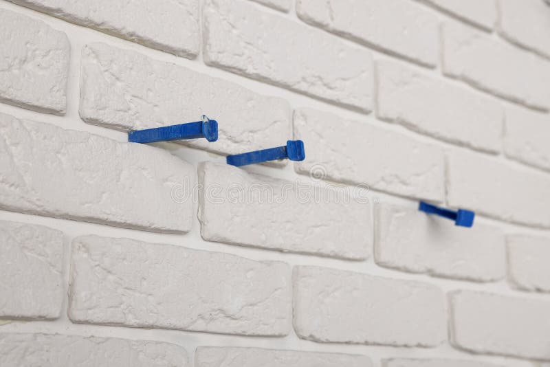 Decorative White Bricks with Tile Leveling System on Wall, Closeup ...