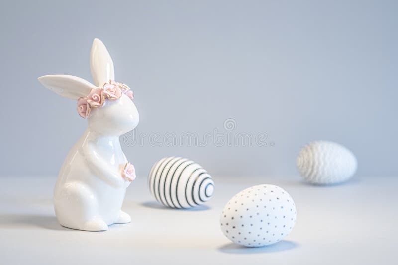 Decorative White Rabbit Figurine with Floral Crown and Easter Eggs in a ...