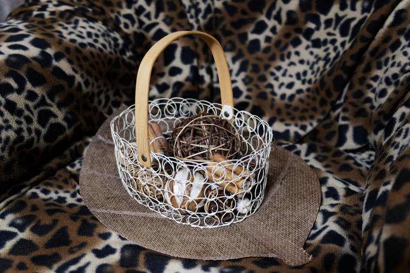 Decorative Wire Basket with Abstract Objects Stands on an Armchair ...