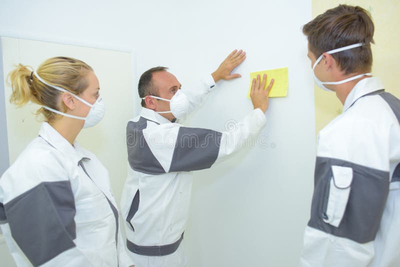 Decorator Demonstrating How To Rub Down Wall Stock Image - Image of ...
