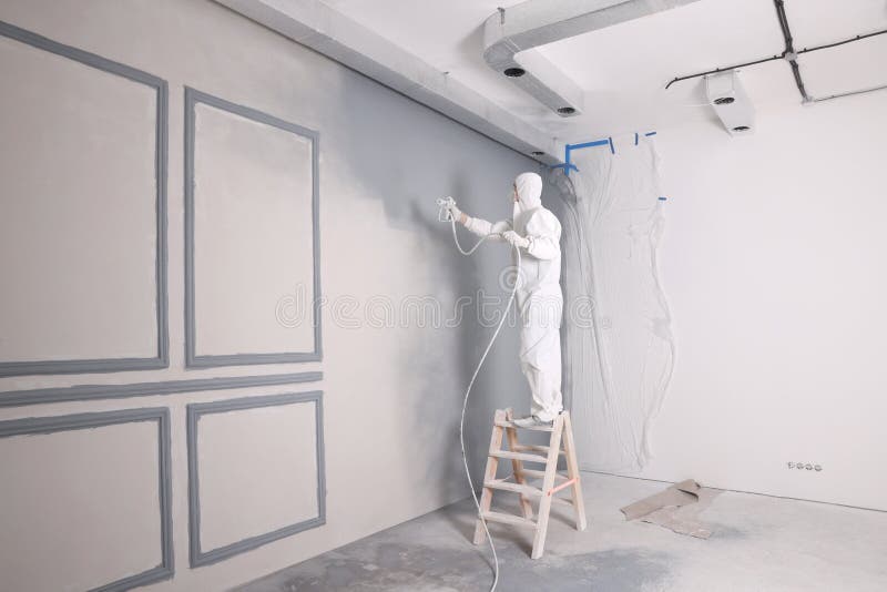 Decorator Dyeing Wall in Grey Color with Spray Paint Indoors Stock ...