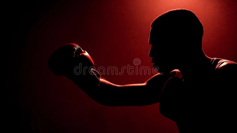 Boxing Athlete Training Intensely in Shadow with a Red Background ...