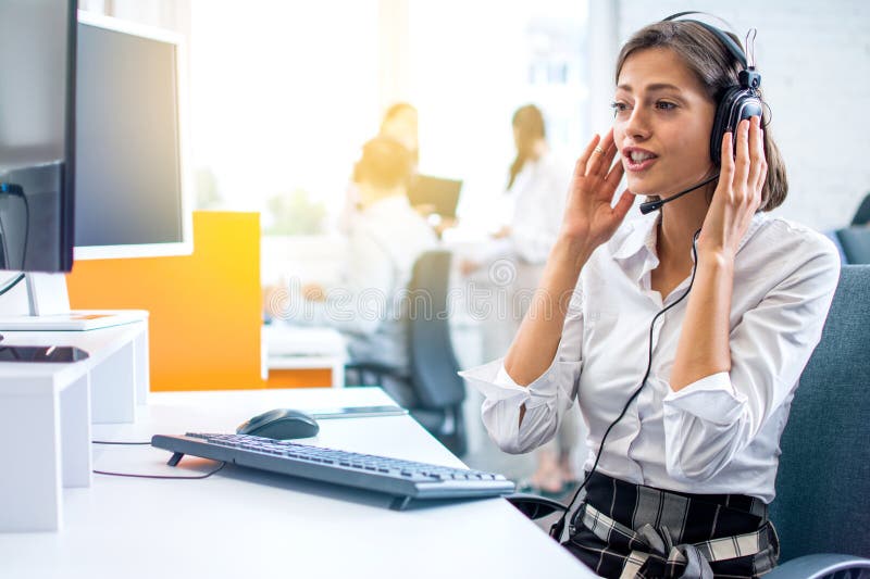 Dedicated Customer Support Agent Operator Intensively Talking To Client and Looking at Computer ...